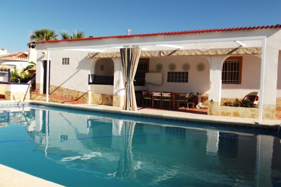 A beautiful detached villa with a swimming pool and a garden ...